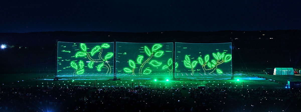 XL video mapping effects on outdoor projection scrims at Sky Song